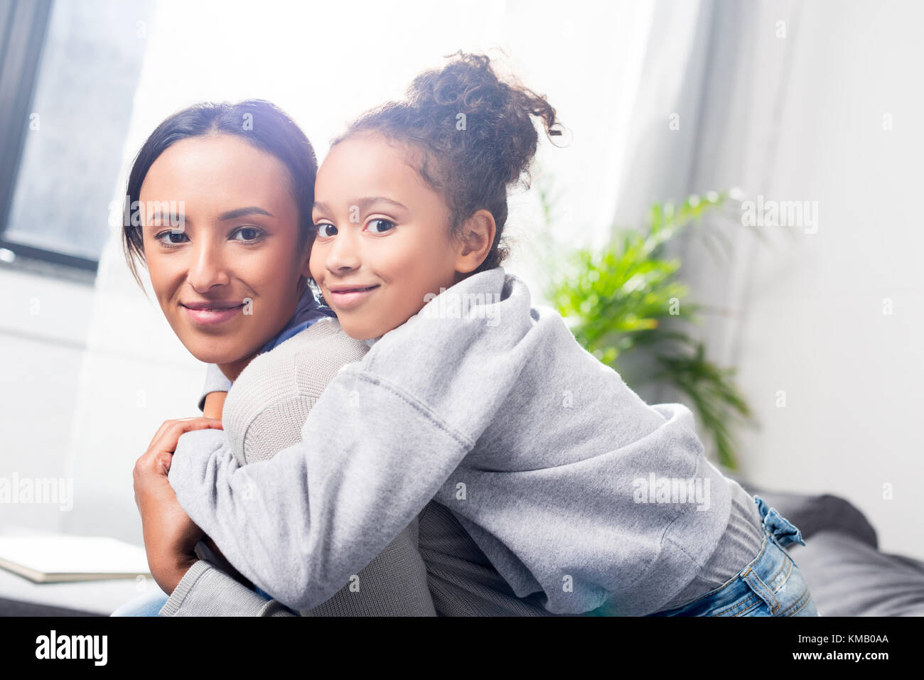 daughter hugging her mother Stock Photo - Alamy