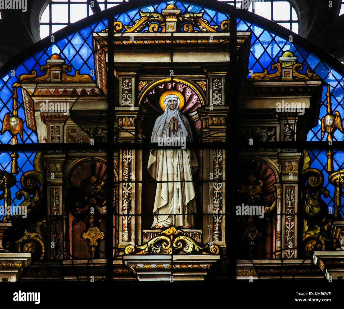 Stained Glass window depicting a Praying Saint in a White Habit, in the ...