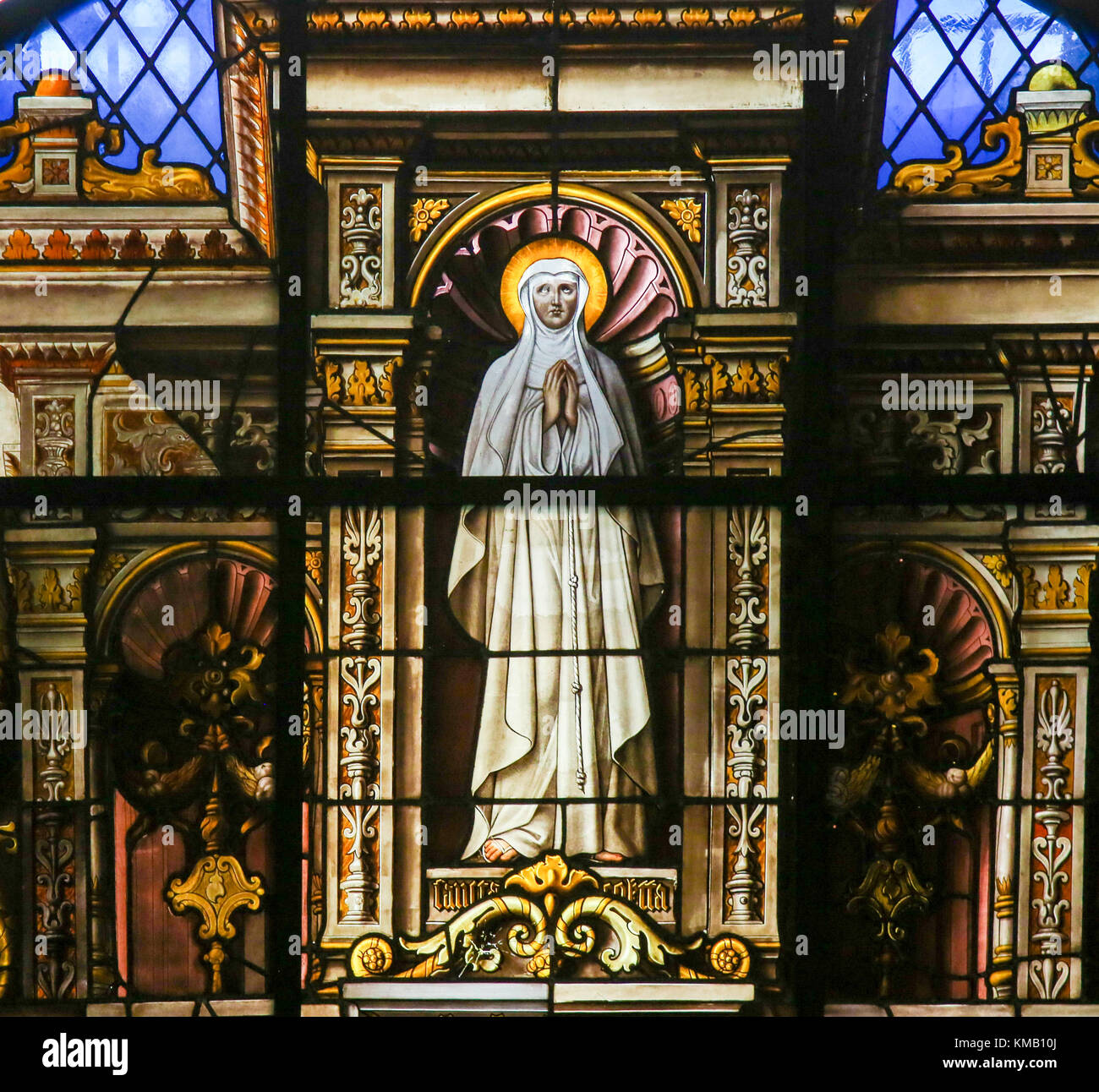 Stained Glass window depicting a Praying Saint in a White Habit, in the ...