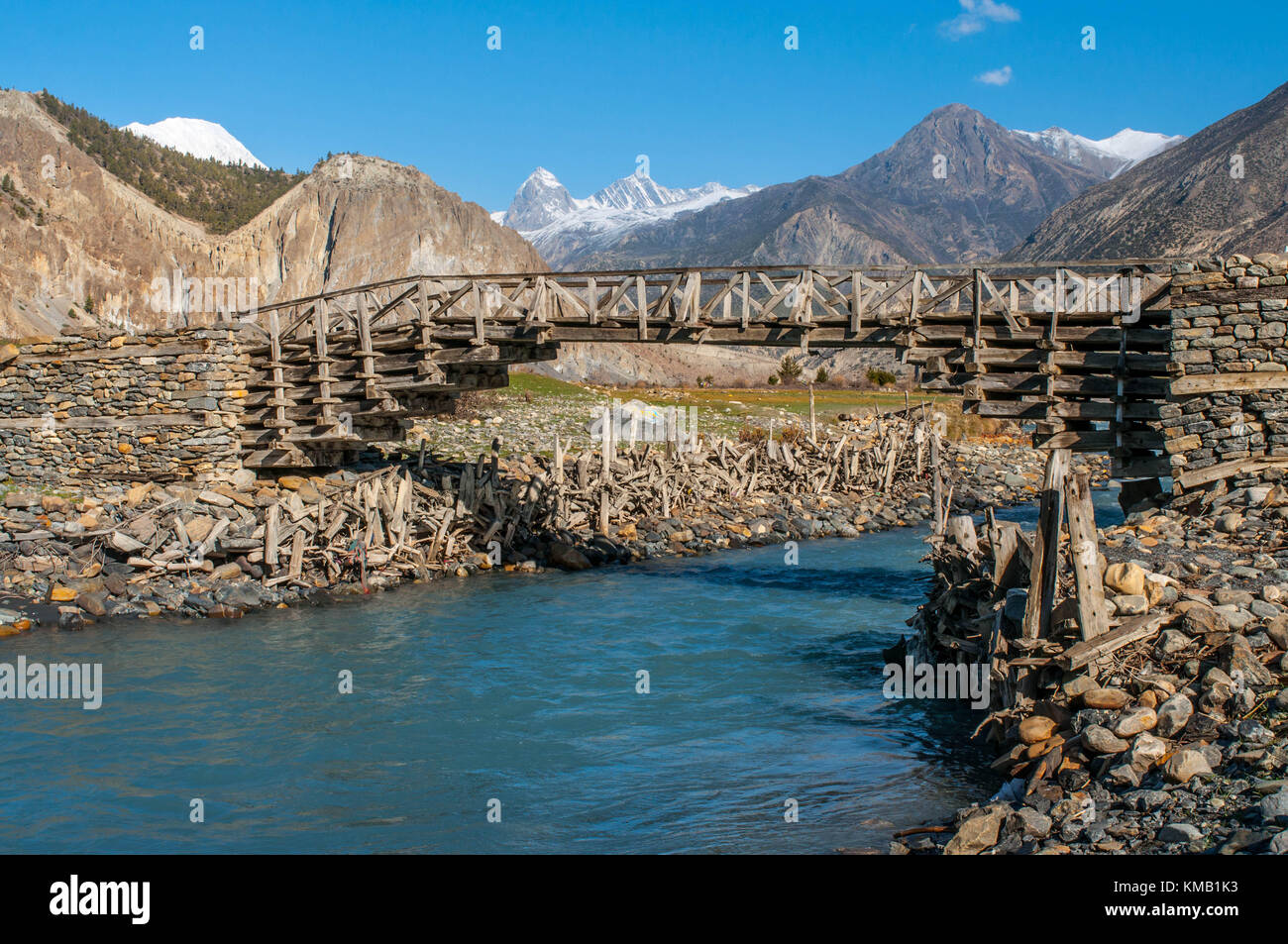 Wooden bridge across the mountain river in Himalayas, Nepal Stock Photo ...