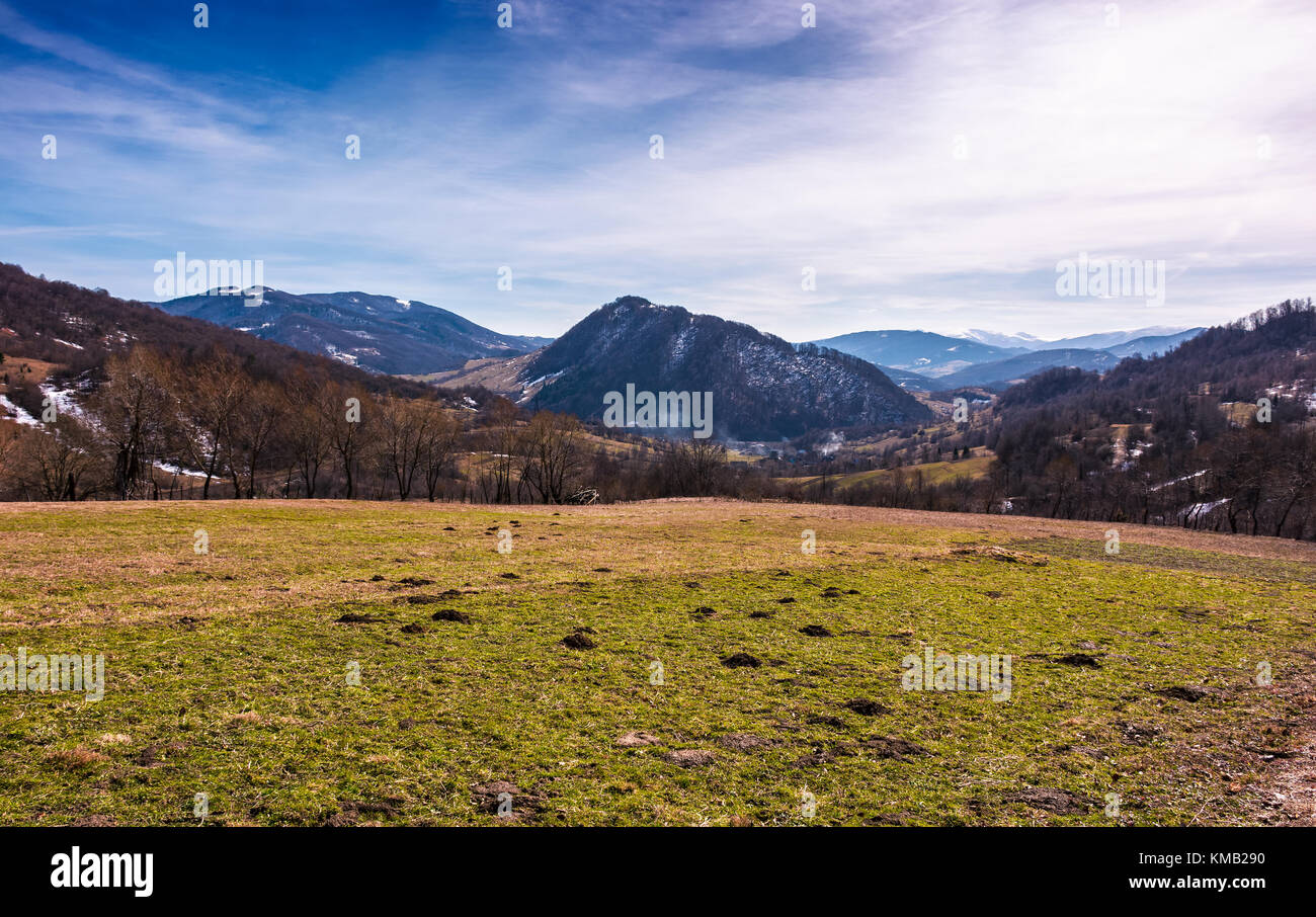 grassy field on an slope in springtime. lovely countryside landscape in ...