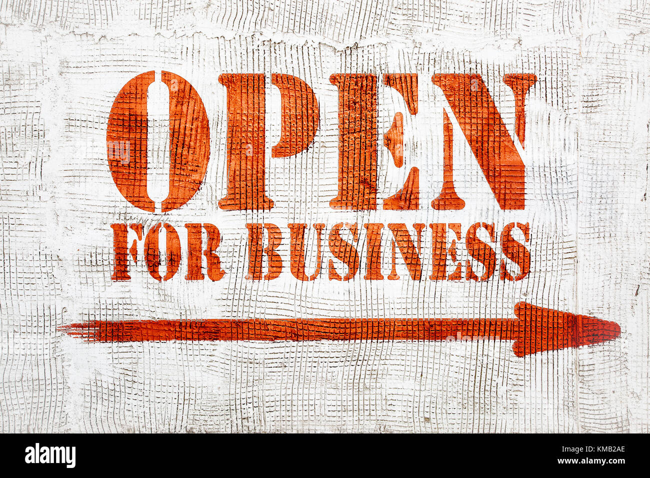 open for business - red graffiti sign with arrow on a white stucco wall ...