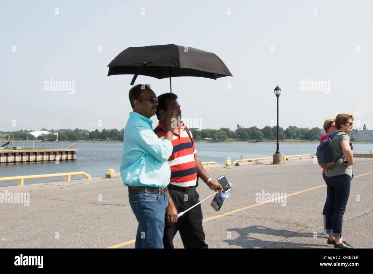 People waving goodbye to people on a Steam boat in Kingston Canada ...