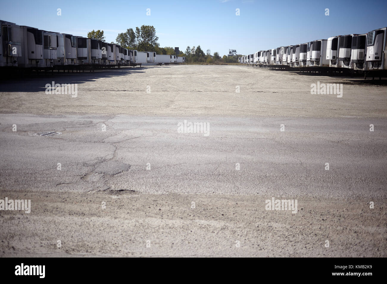 Parking lot of two long rows of freight refrigerator containers with ...
