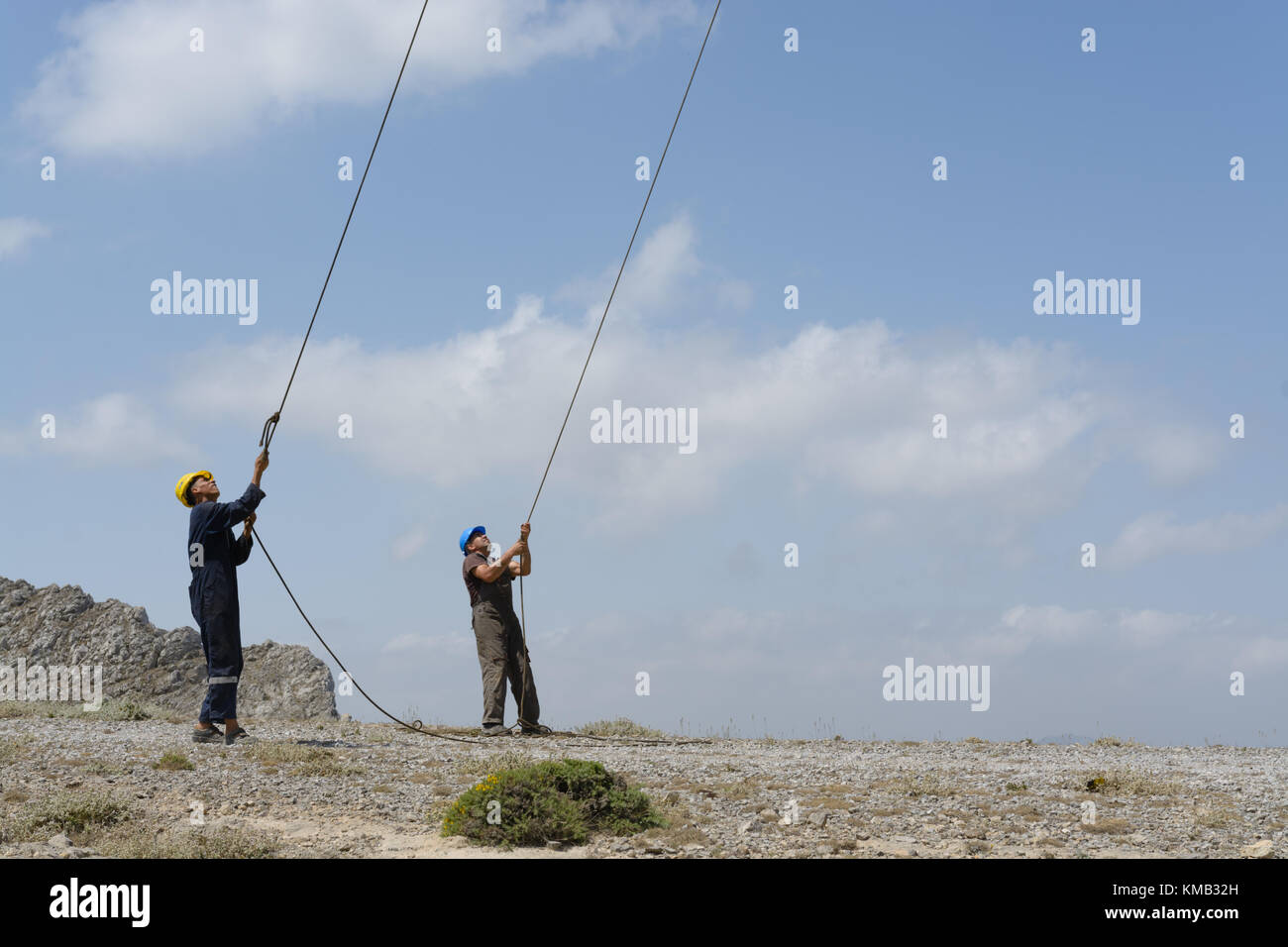 Workers pulling cables to mount a wind turbine Stock Photo - Alamy