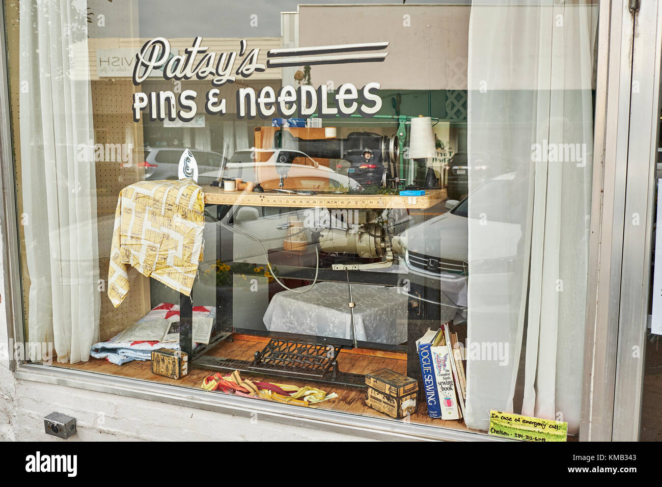 Vintage style sewing shop store front window in small rural town in the ...
