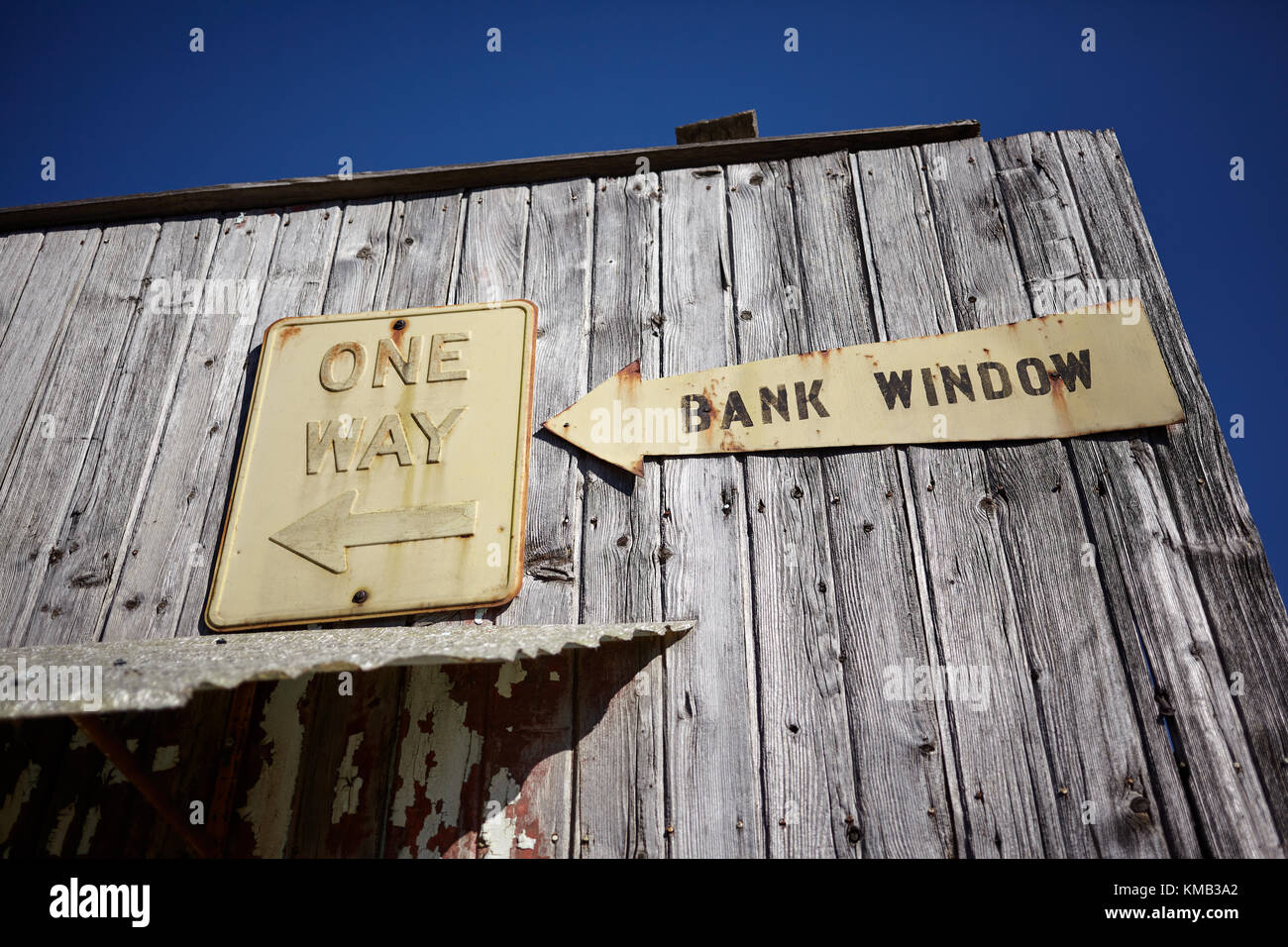 Old weathered timber clad building with bank sign for a Bank Window ...