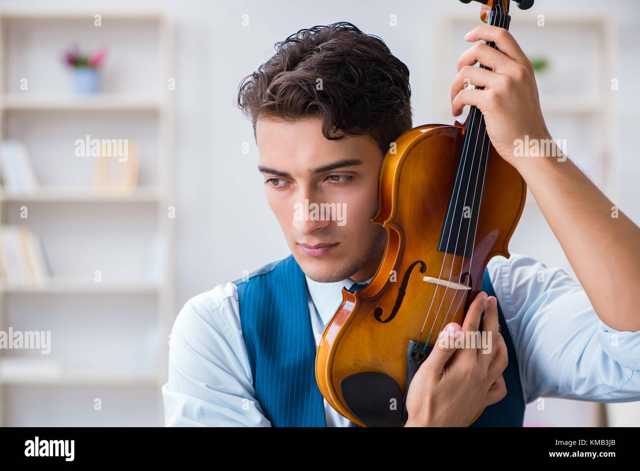 Young musician man practicing playing violin at home Stock Photo - Alamy