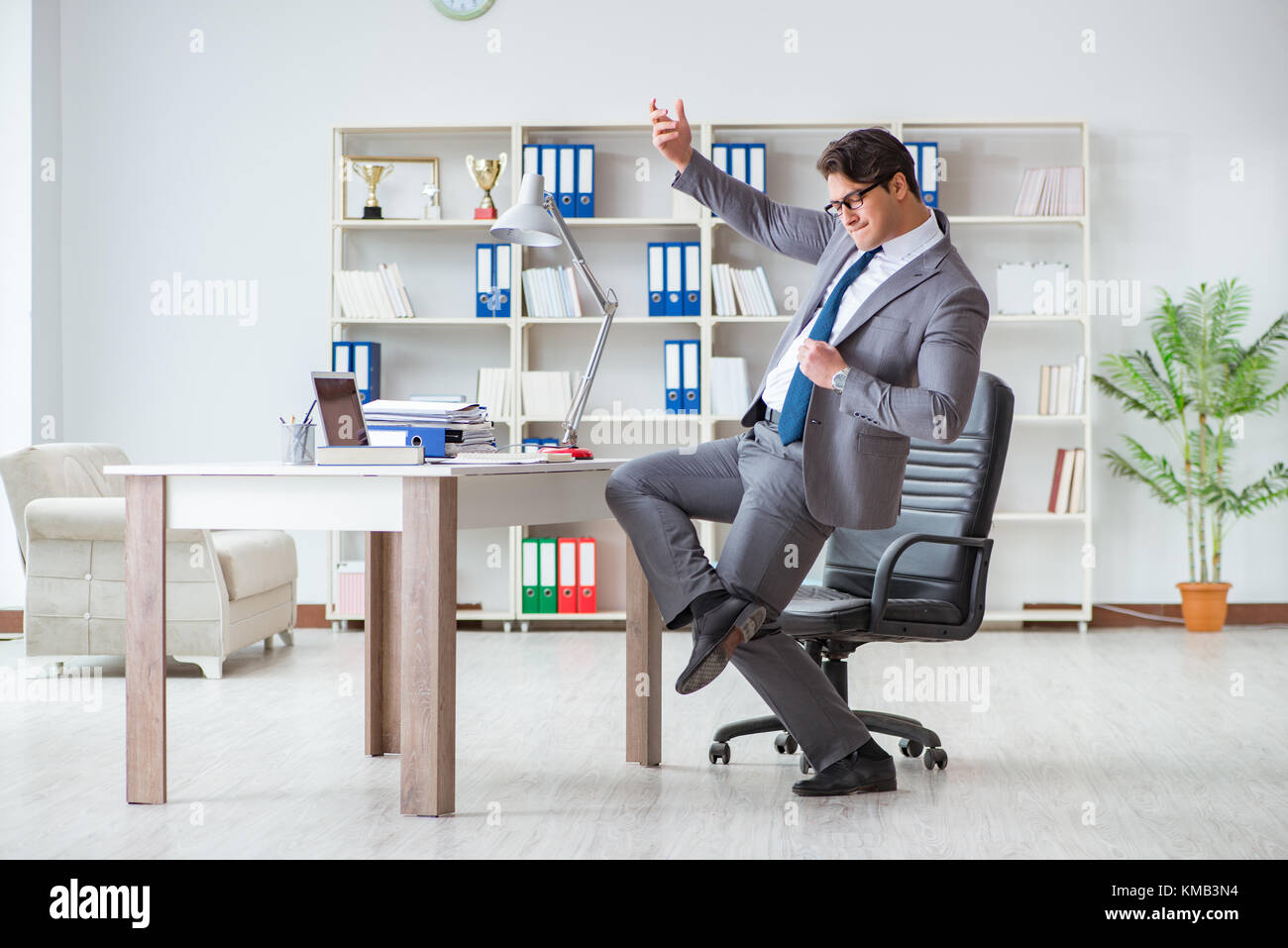 Businessman having fun taking a break in the office at work Stock Photo ...