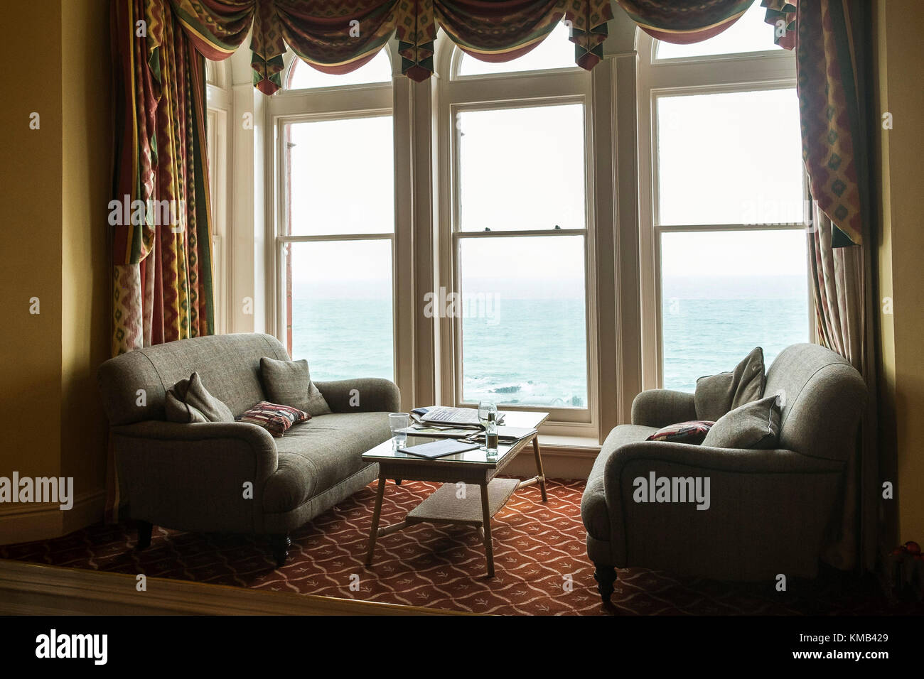 Two sofas settees in a window bay of a hotel Stock Photo - Alamy