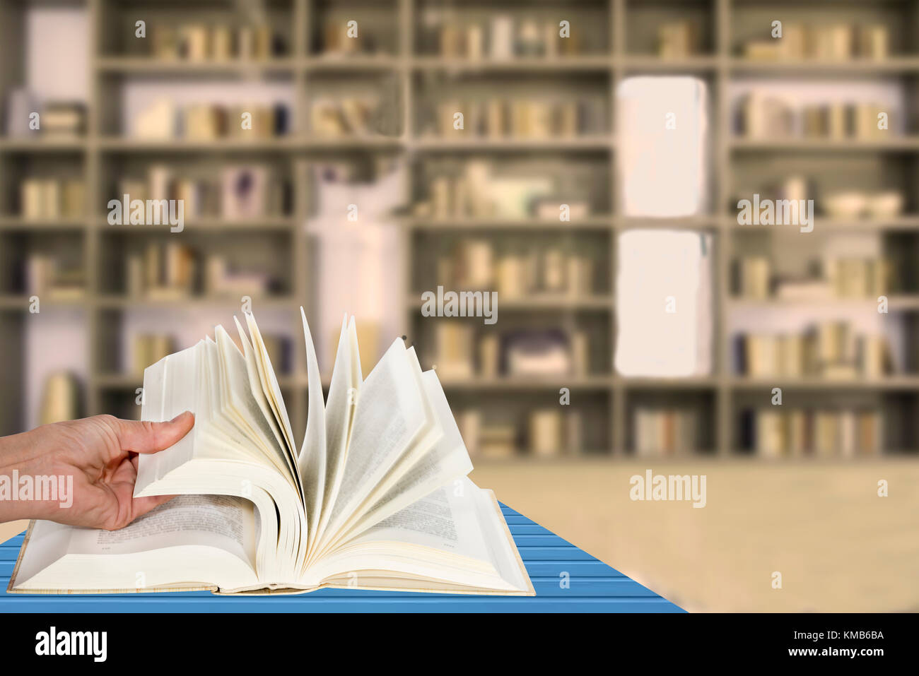Passing the pages of a book with a library in the background Stock ...