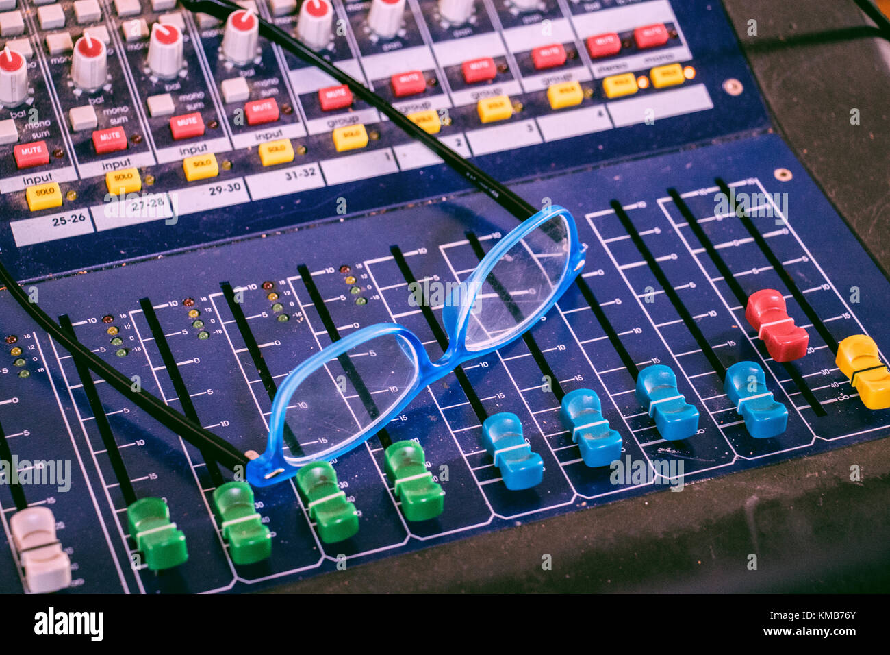 Sound engineer pause. Glasses over a sound mixer Stock Photo - Alamy