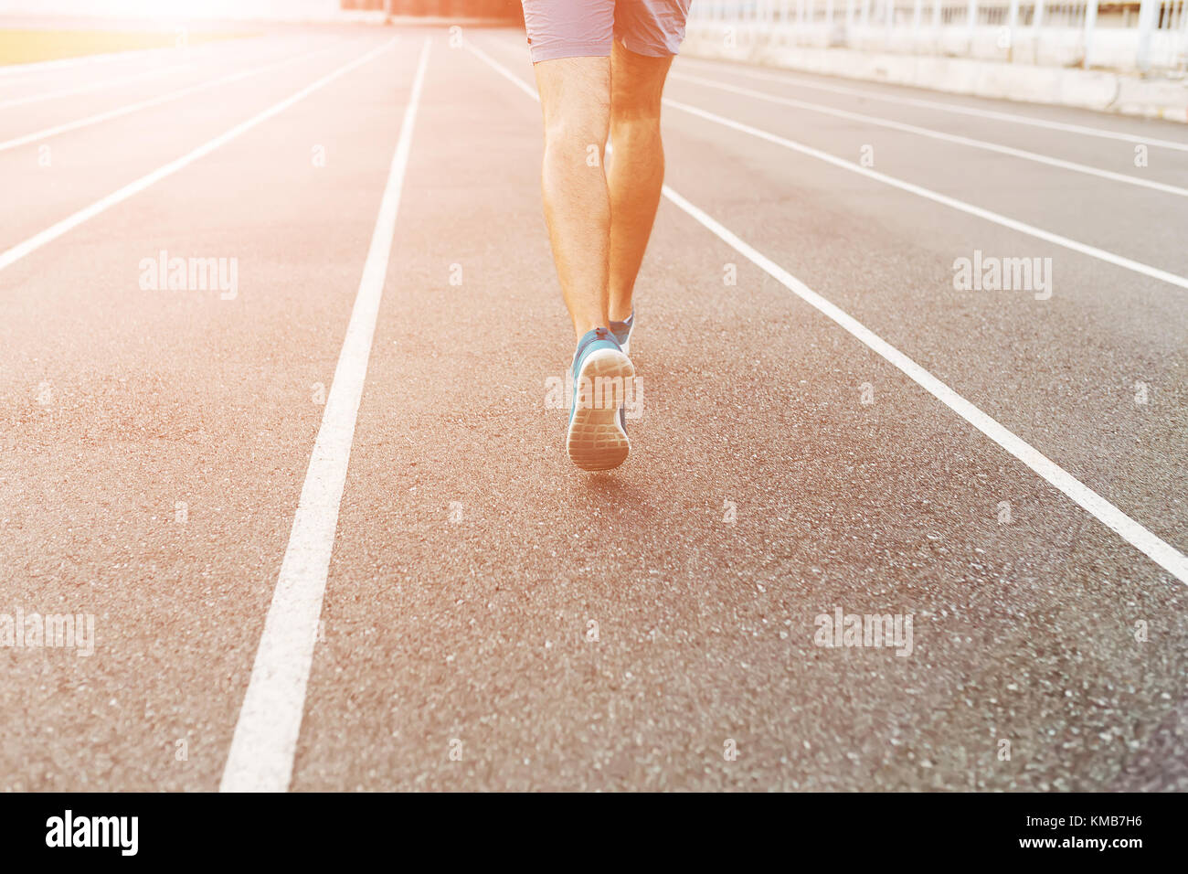 Man athlete runner feet and shoes running along stadium lanes Stock ...