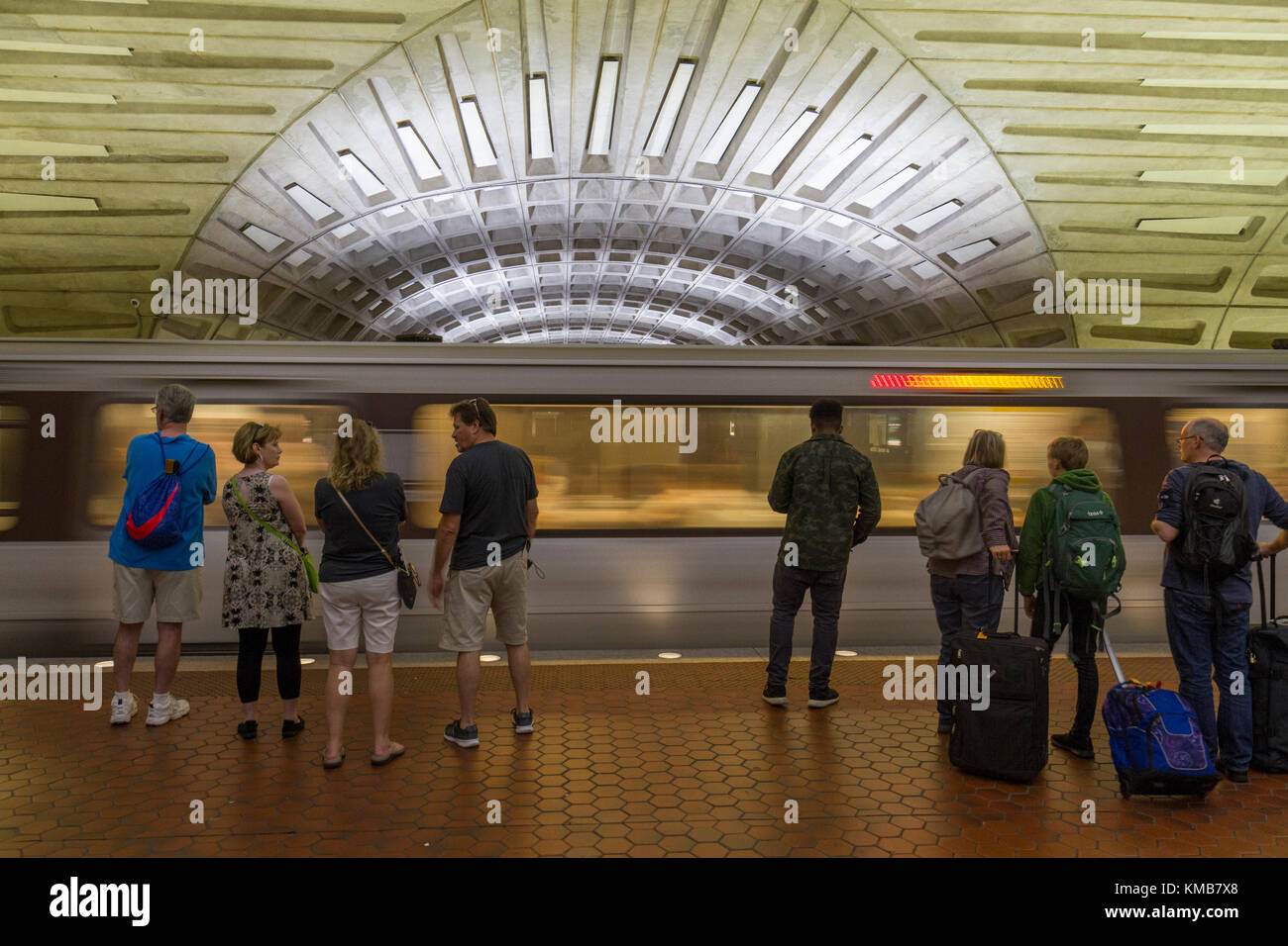 Passengers waiting for a WMATA DC Metro train arriving at a station ...