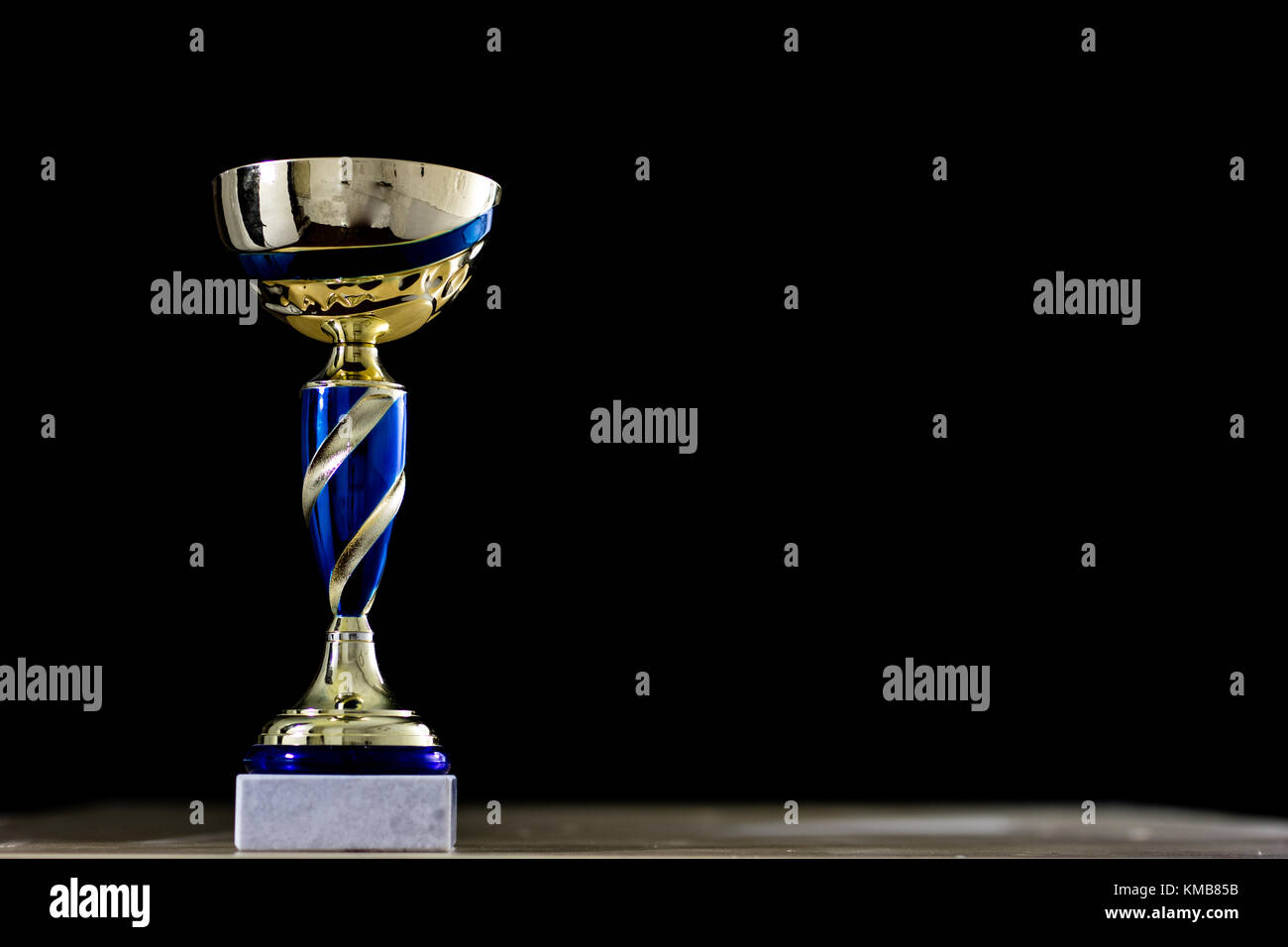 prize, a cup standing on the table. Cup award on a black background ...