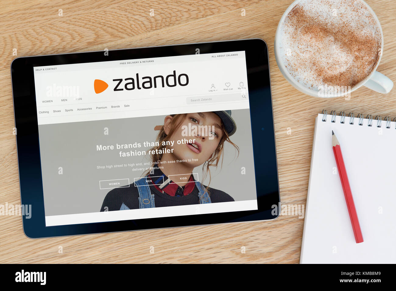 The Zalando website features on an iPad tablet device which rests on a ...