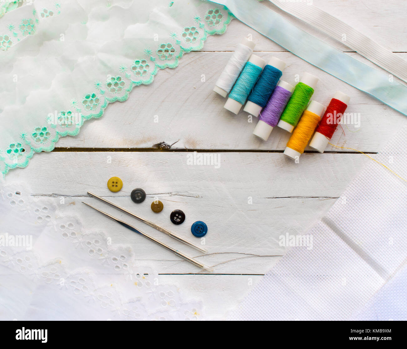 Thread spool, colorful sewing thread lines, metal needles and shirt ...