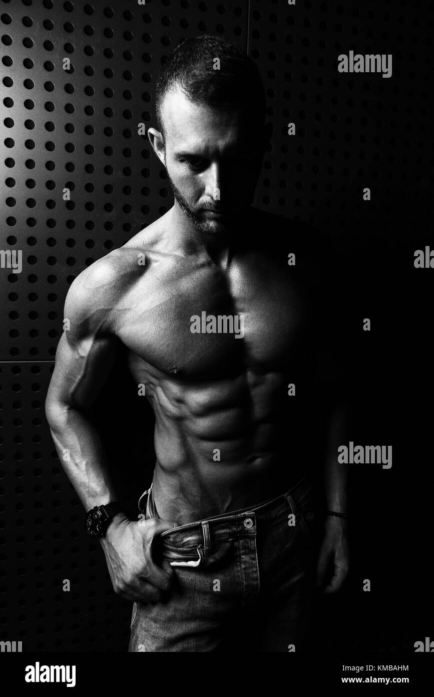 Healthy Young Man Standing Strong Standing Against a Wall and Flexing ...