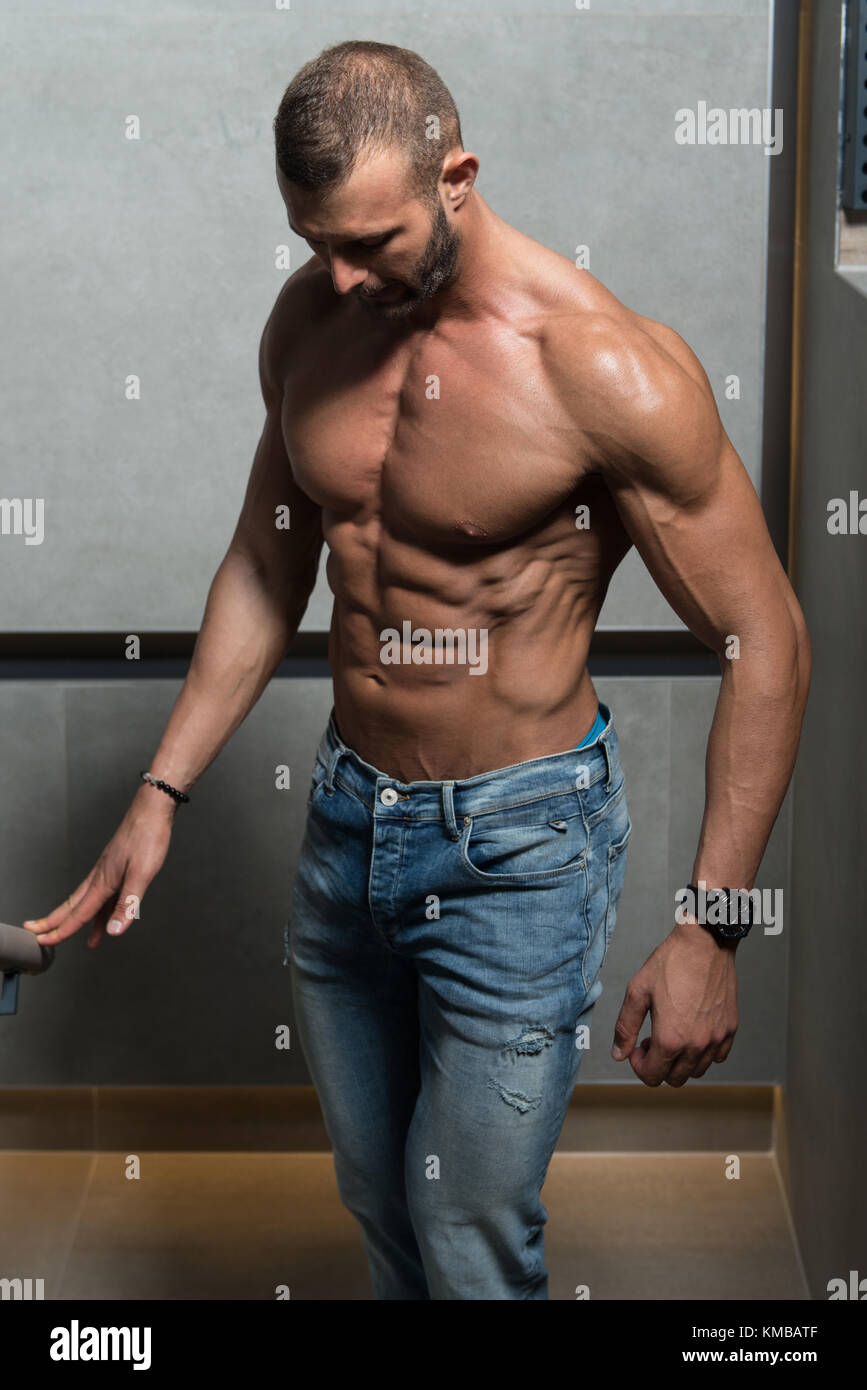 Healthy Young Man Standing Strong Standing Against a Wall and Flexing ...