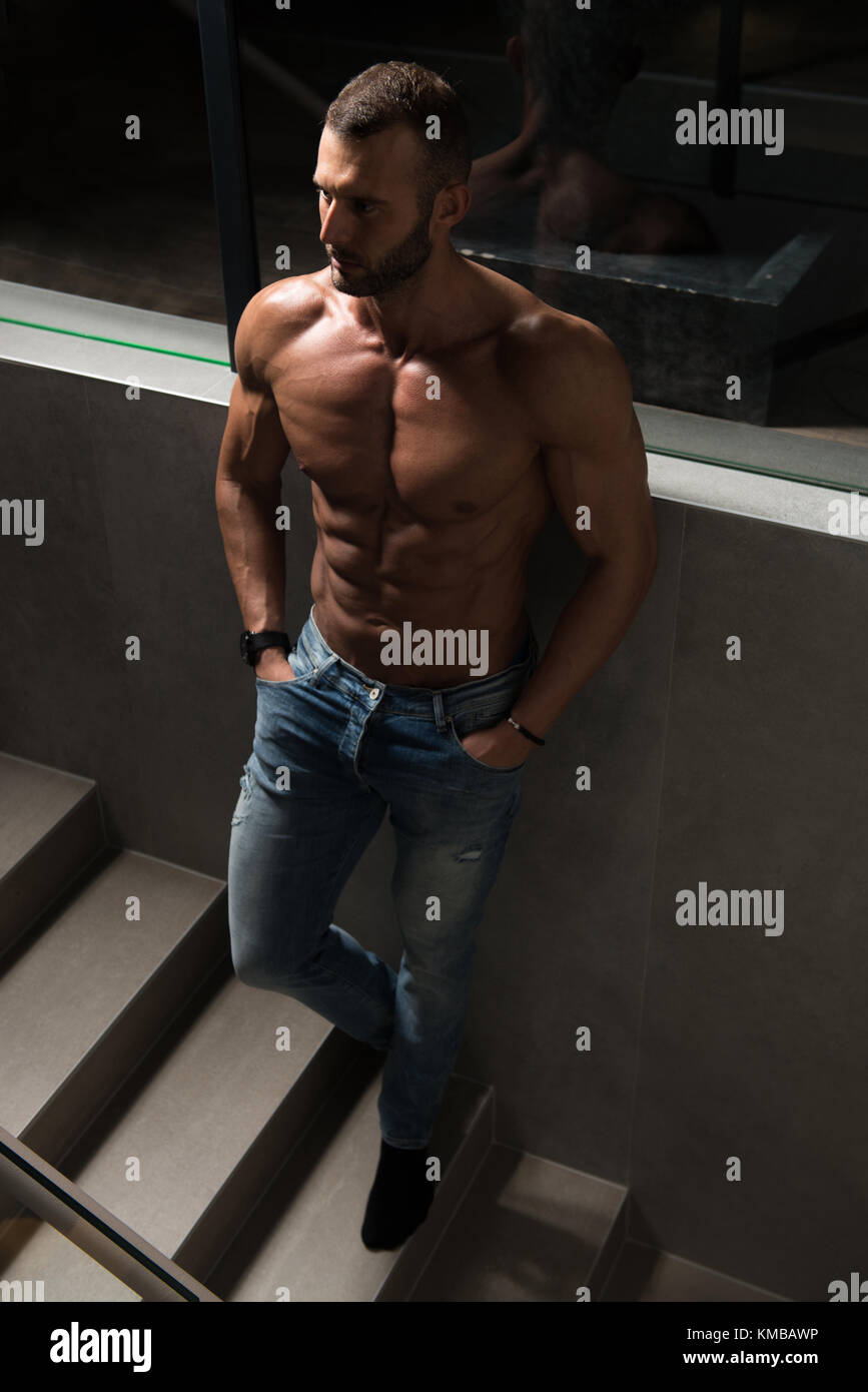 Healthy Young Man Standing Strong Standing On Stairs and Flexing ...