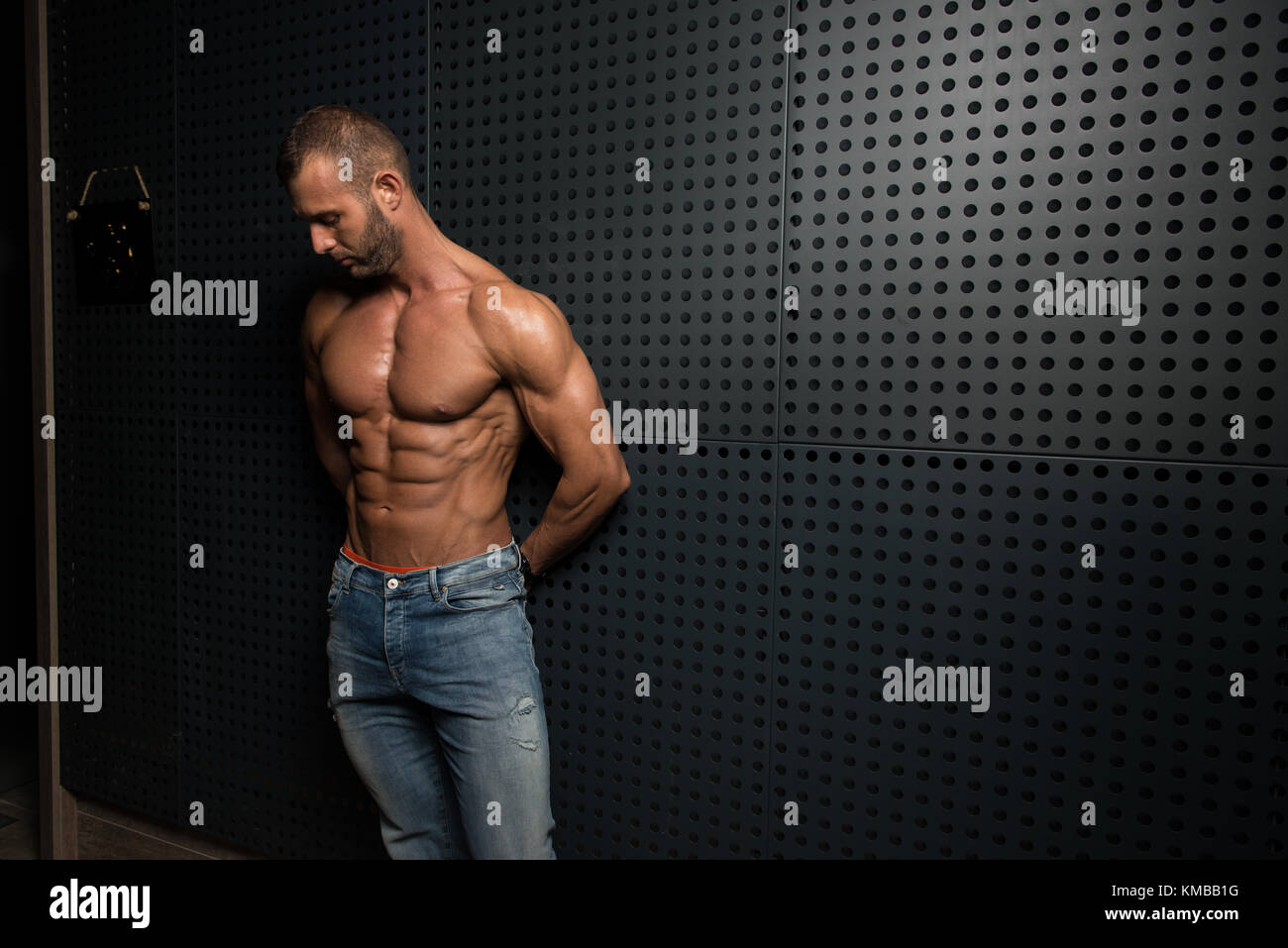Healthy Young Man Standing Strong Standing Against a Wall and Flexing ...