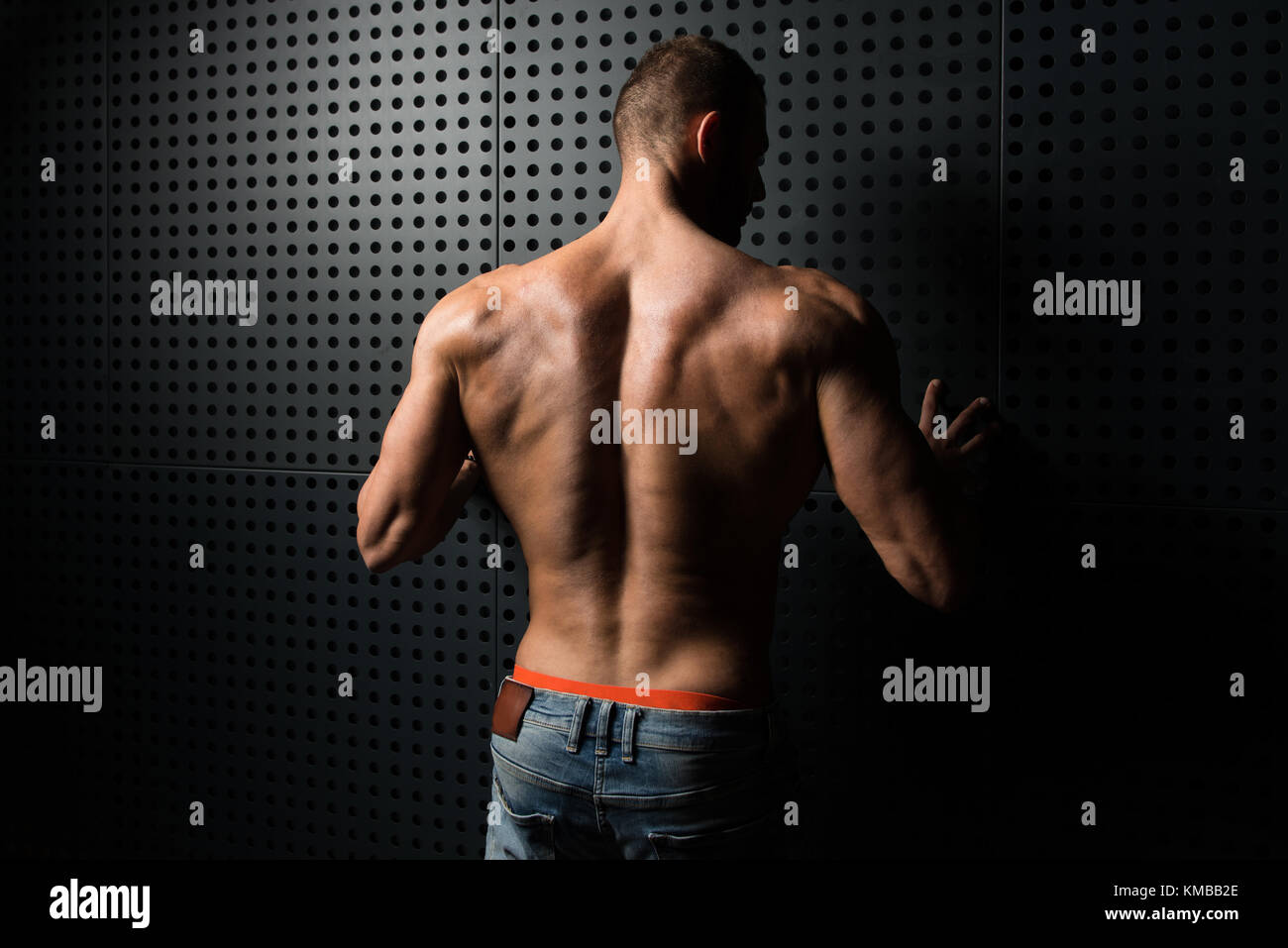Healthy Young Man Standing Strong Standing Against a Wall and Flexing ...