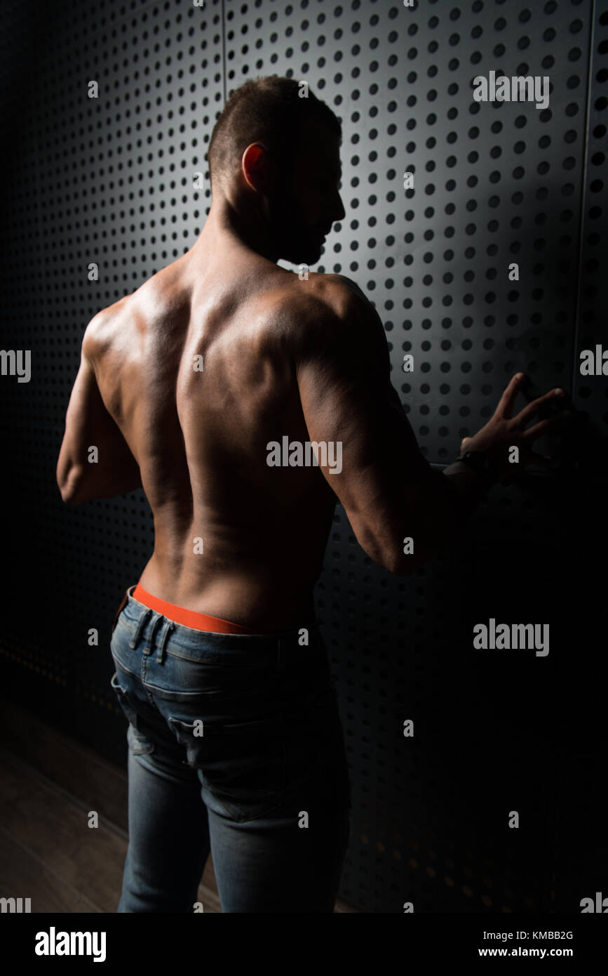 Healthy Young Man Standing Strong Standing Against a Wall and Flexing ...