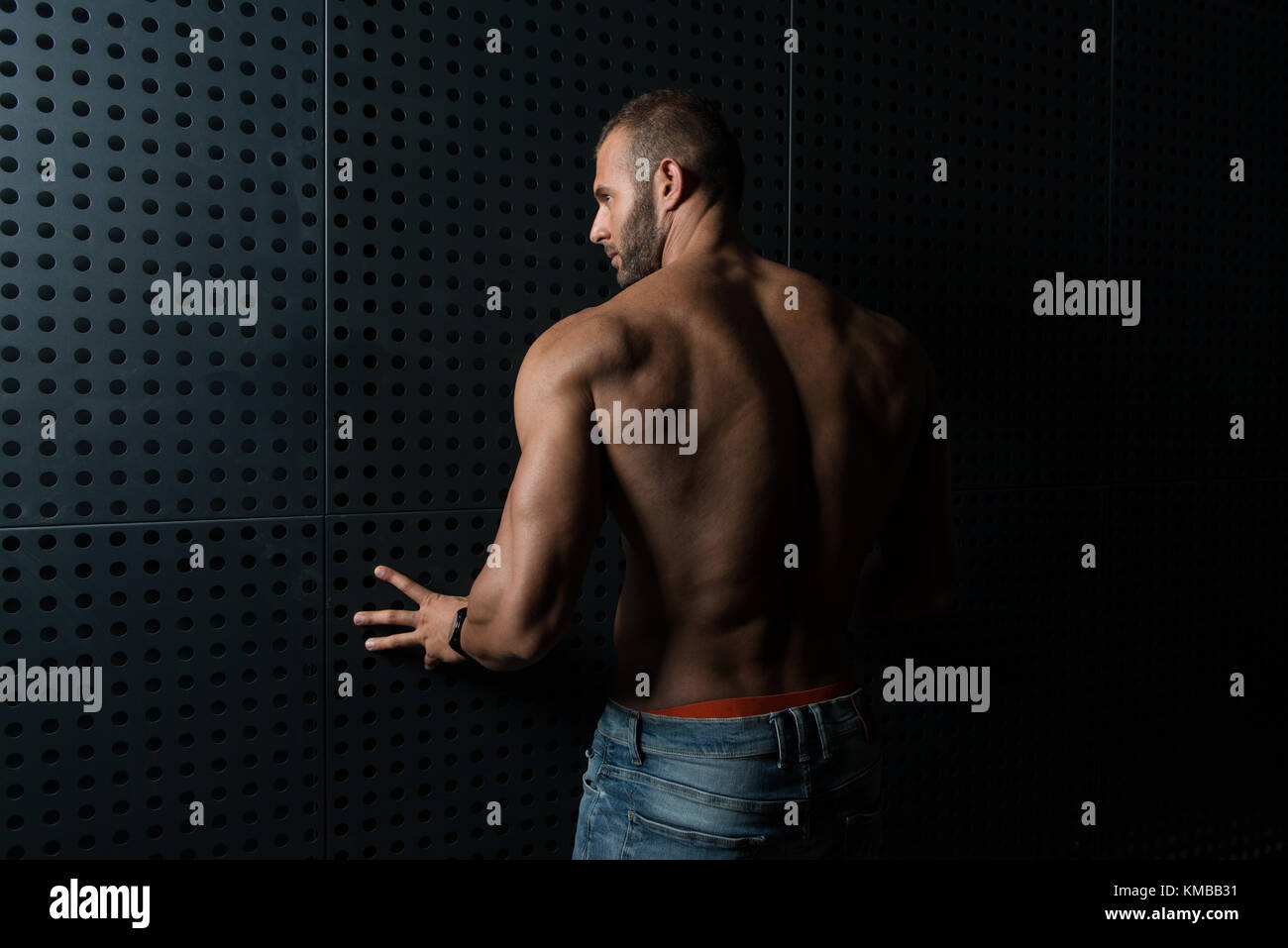 Healthy Young Man Standing Strong Standing Against a Wall and Flexing ...