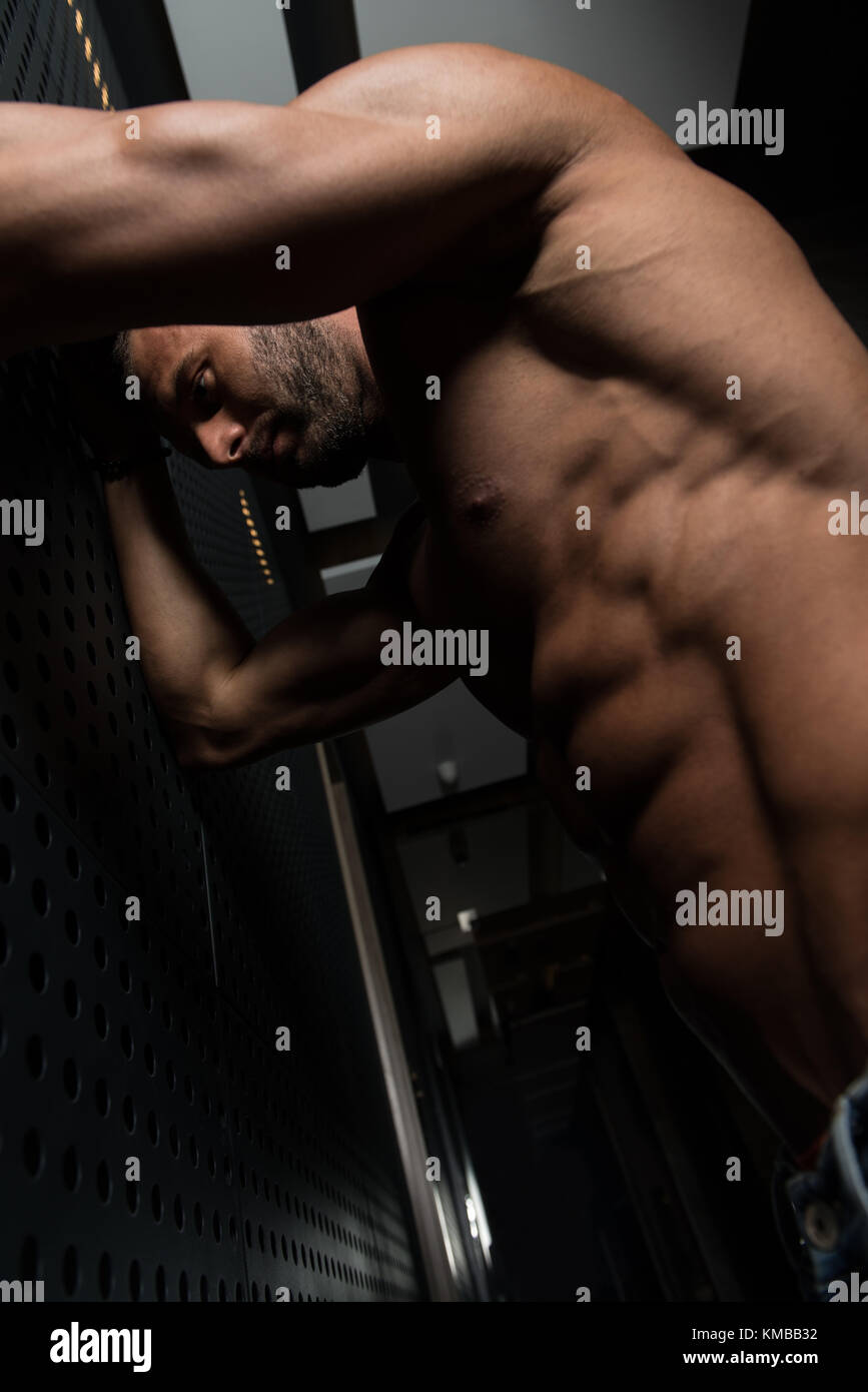 Healthy Young Man Standing Strong Standing Against a Wall and Flexing ...