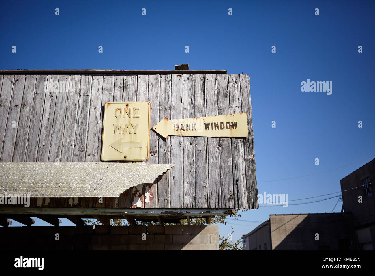 Side view of vintage wooden wild west bank building with left pointing ...