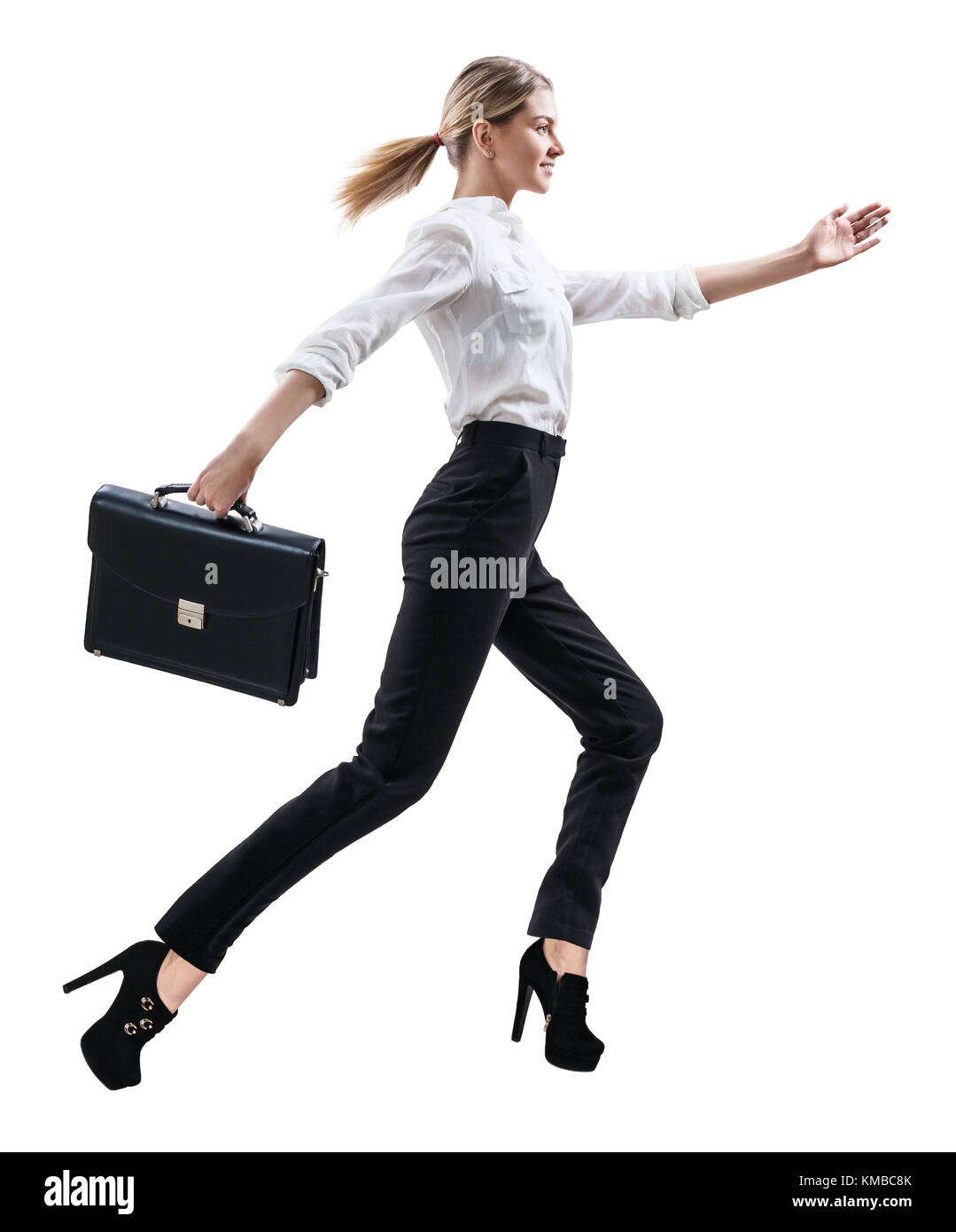 Happy young woman in formal wear jumping Stock Photo - Alamy