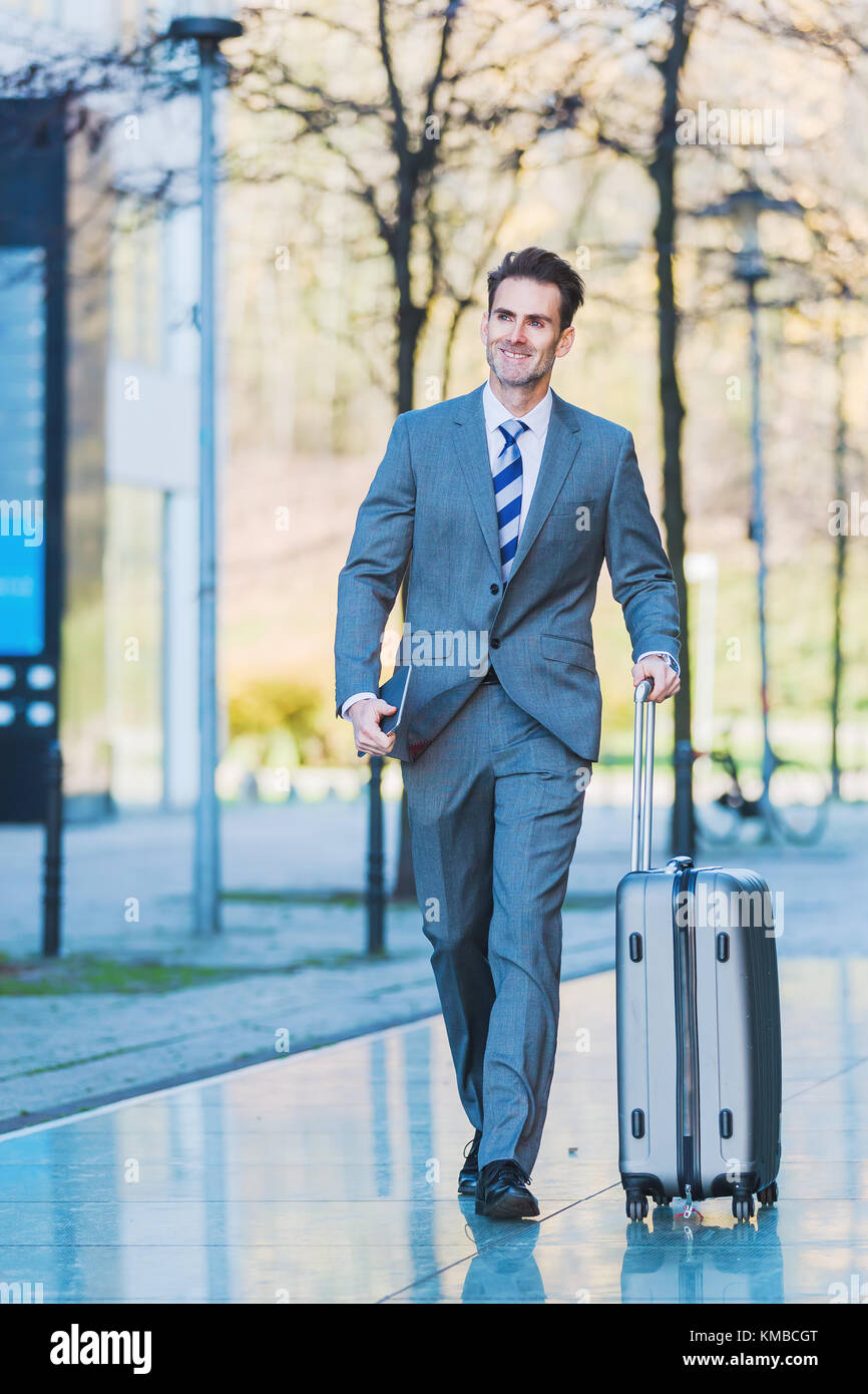 picture of a businessman who walks with a trolley bag in the city Stock ...