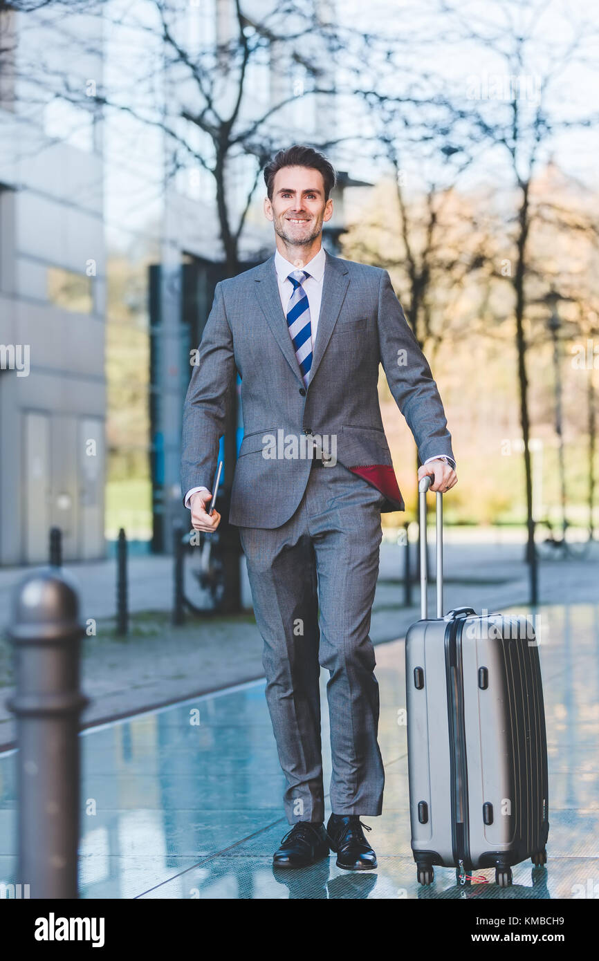 picture of a businessman who walks with a trolley bag in the city Stock ...
