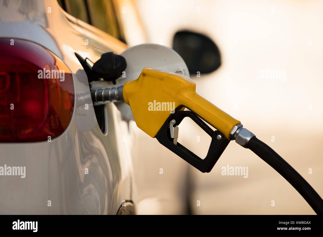 white car at gas station being filled with fuel Stock Photo - Alamy