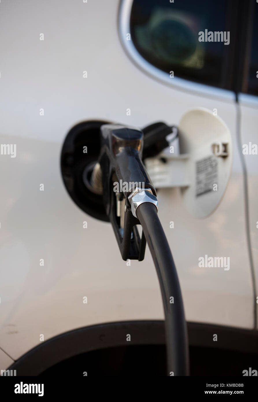 white car at gas station being filled with fuel Stock Photo - Alamy