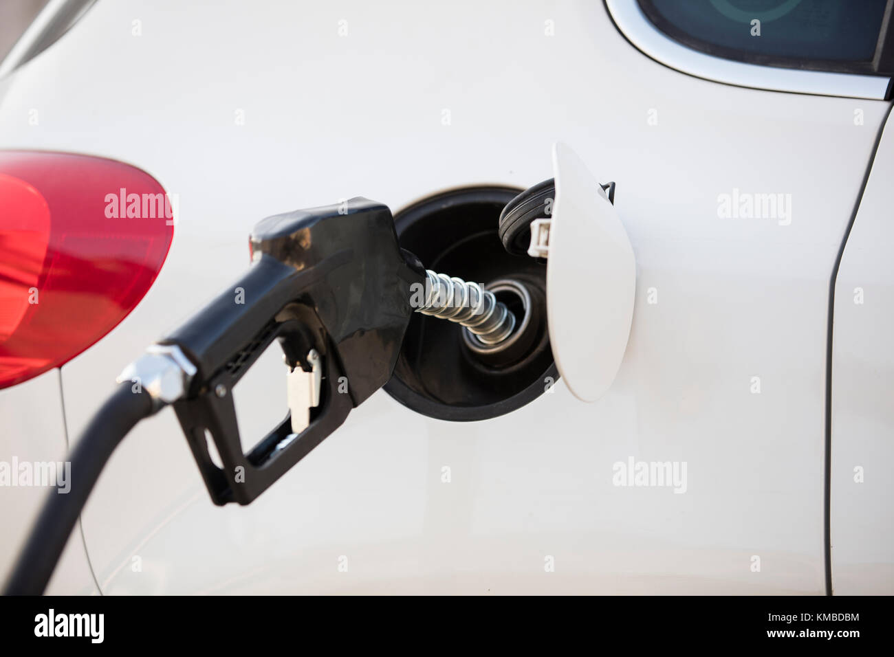 white car at gas station being filled with fuel Stock Photo - Alamy