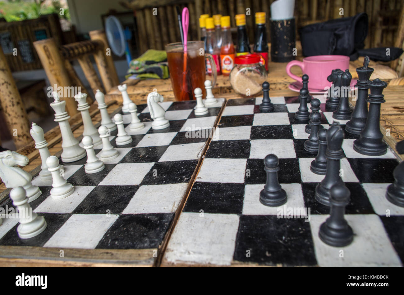 Playing chess in a restaurant in Indonesia Stock Photo - Alamy