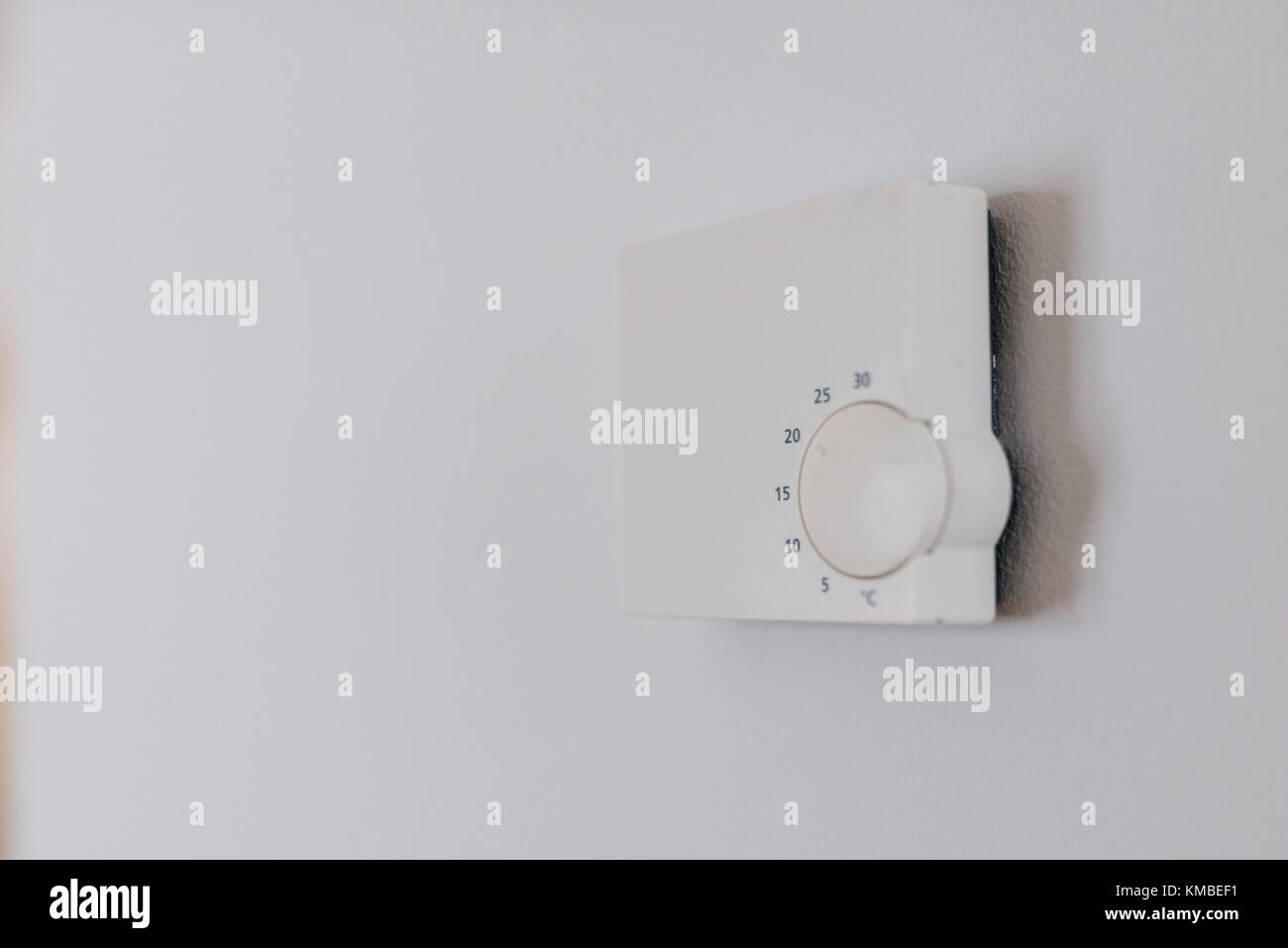 Home heating regulating thermostat on the wall Stock Photo - Alamy