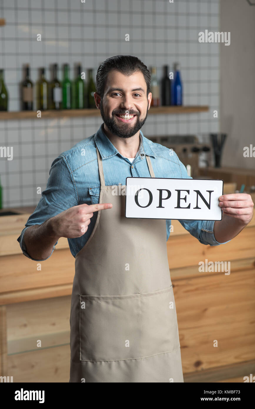 Young smart owner of a cafe showing the opening of this place Stock ...
