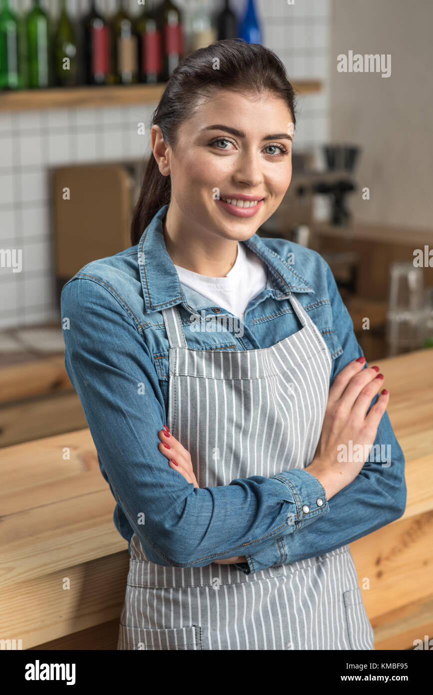 Lovely cheerful waitress standing and waiting for the visitors Stock ...