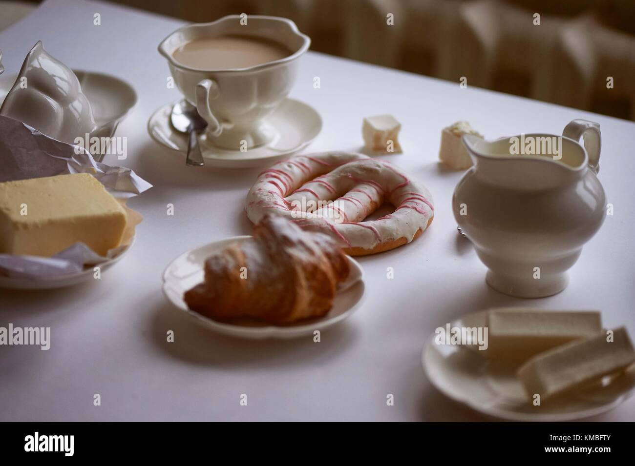 Charming French Breakfast white set and croissants, butter ...