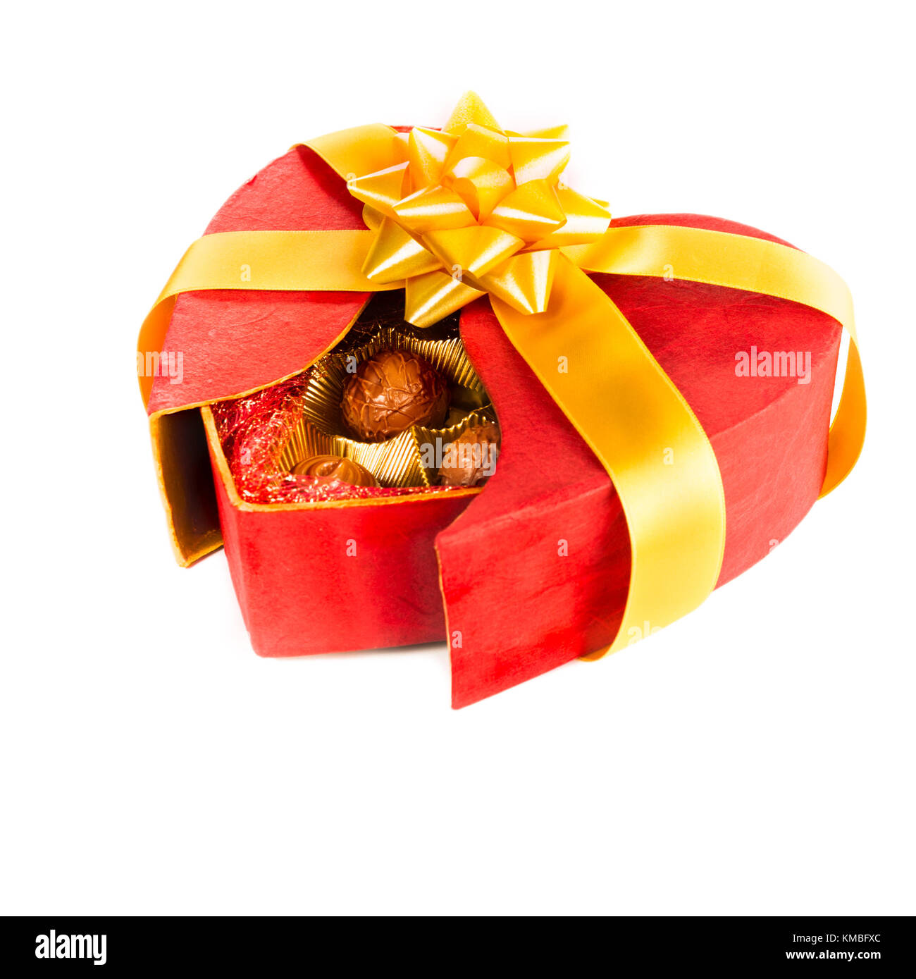 Heart-shaped box of chocolates decorated with ribbons on white ...