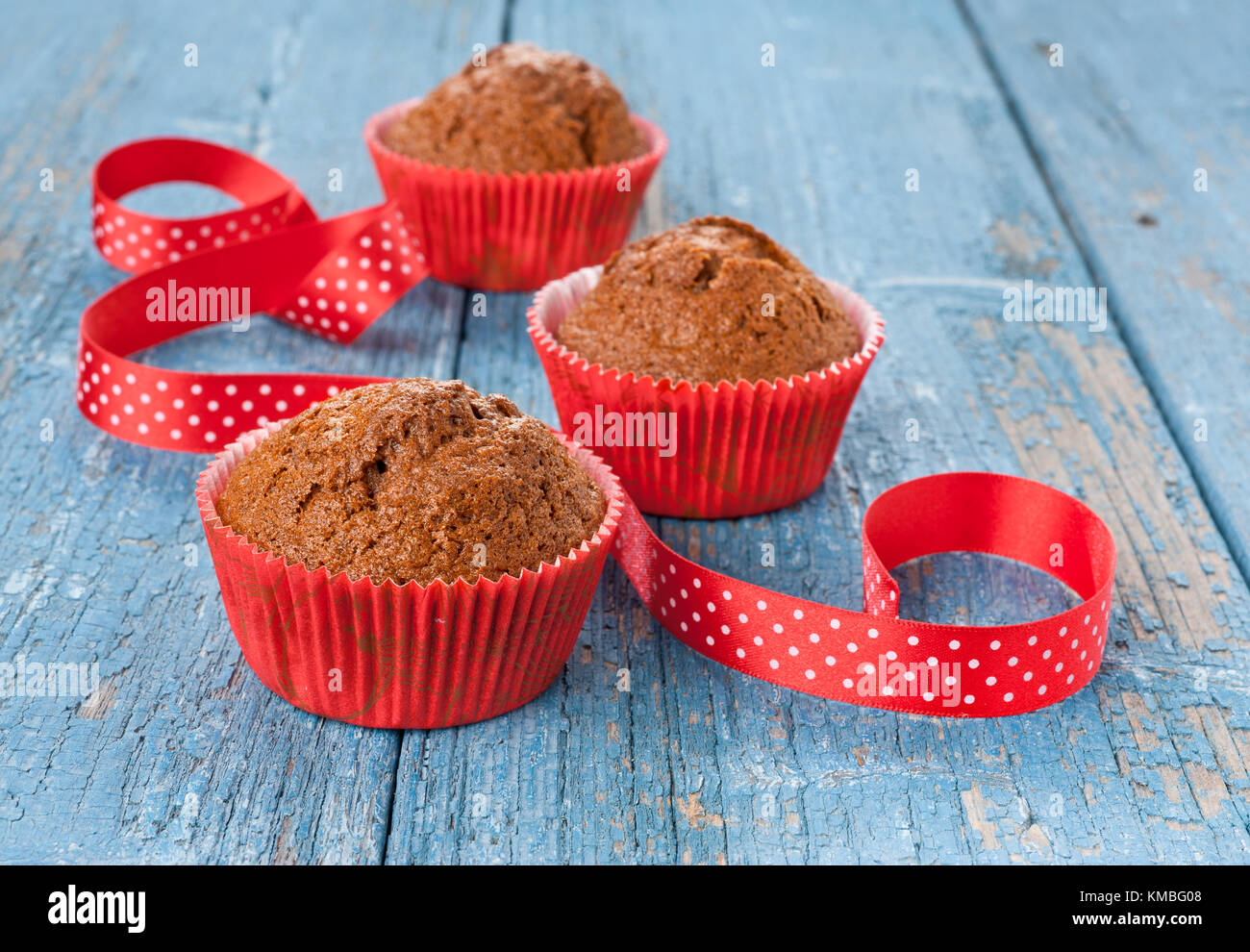 Chocolate muffins in red paper cups decorated with a ribbon Stock Photo ...