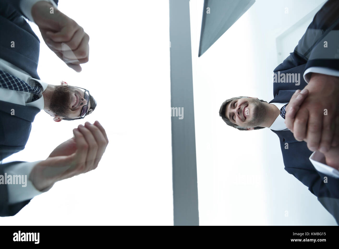 View from below. From behind the glass. Two businessmen sitting at the ...