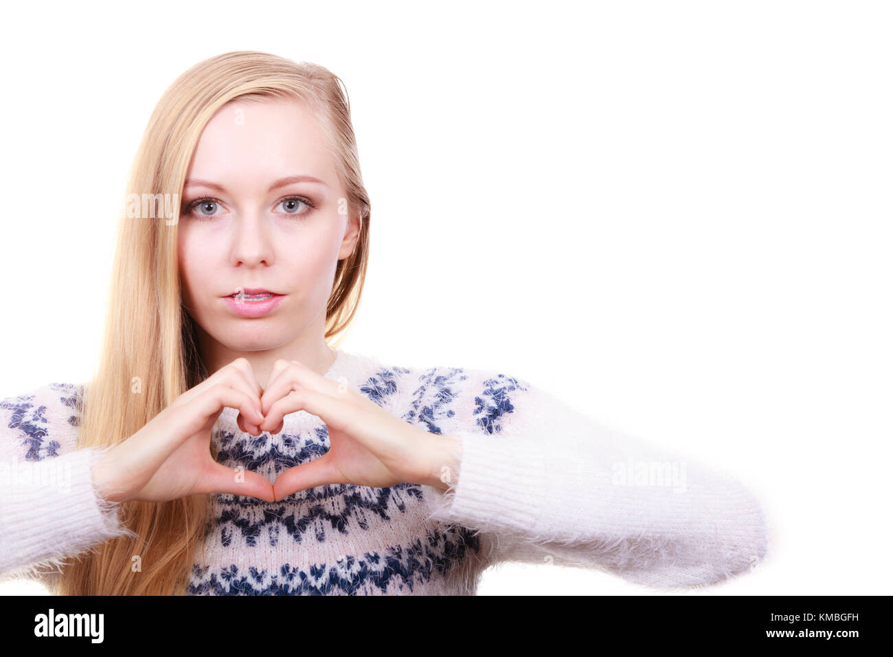 Gestures, signs and symbols concept. Teenage girl making heart sign ...