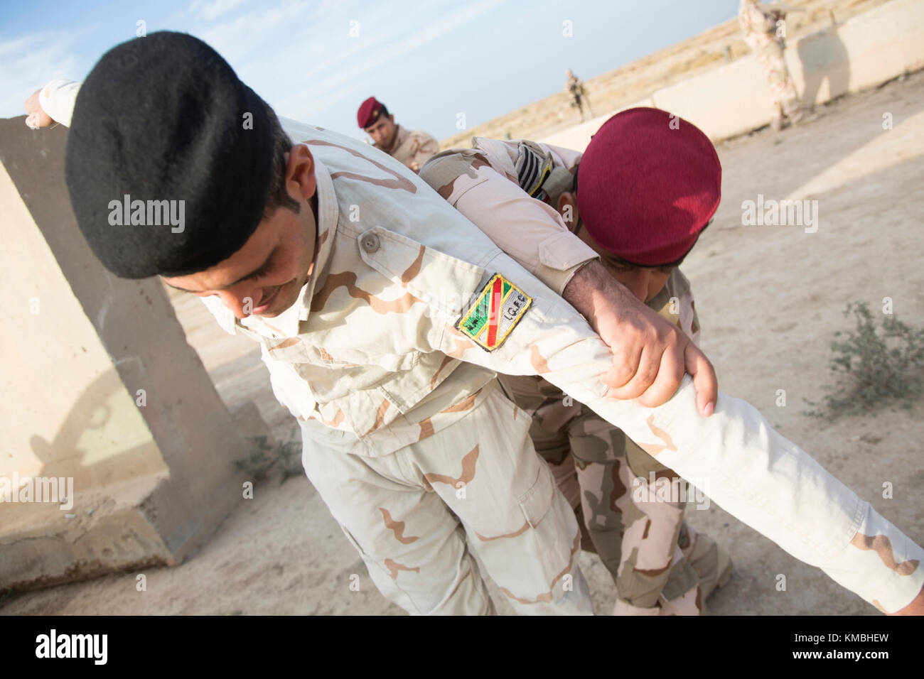 An Iraqi soldier searches a suspect for weapons during checkpoint ...