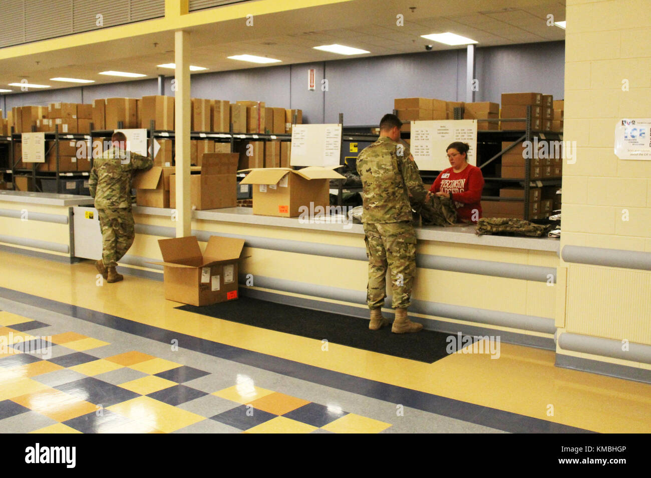 Soldiers work with Central Issue Facility personnel to pick up ...