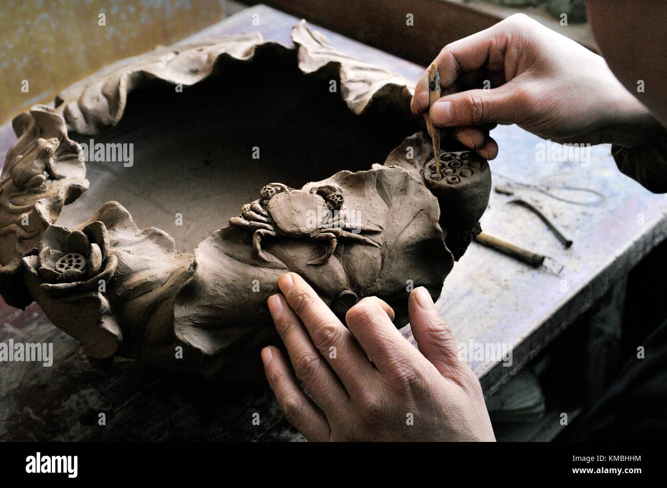 Traditional Longshan Chinese black pottery. Artist finishing bowl ...