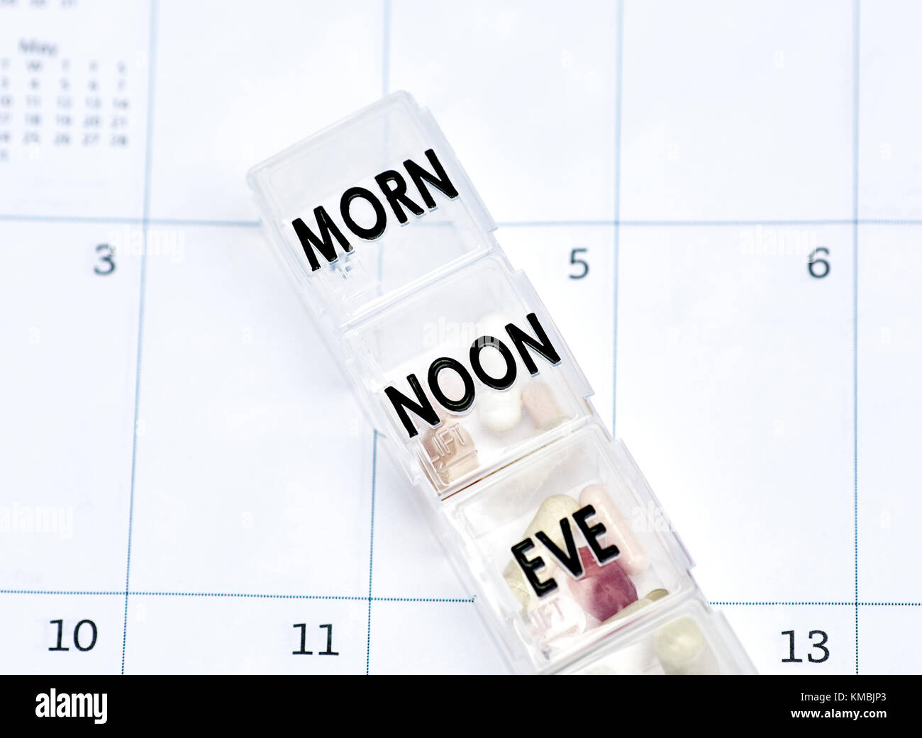 Pill box labeled morn, noon, eve, bed filled with nutritional ...
