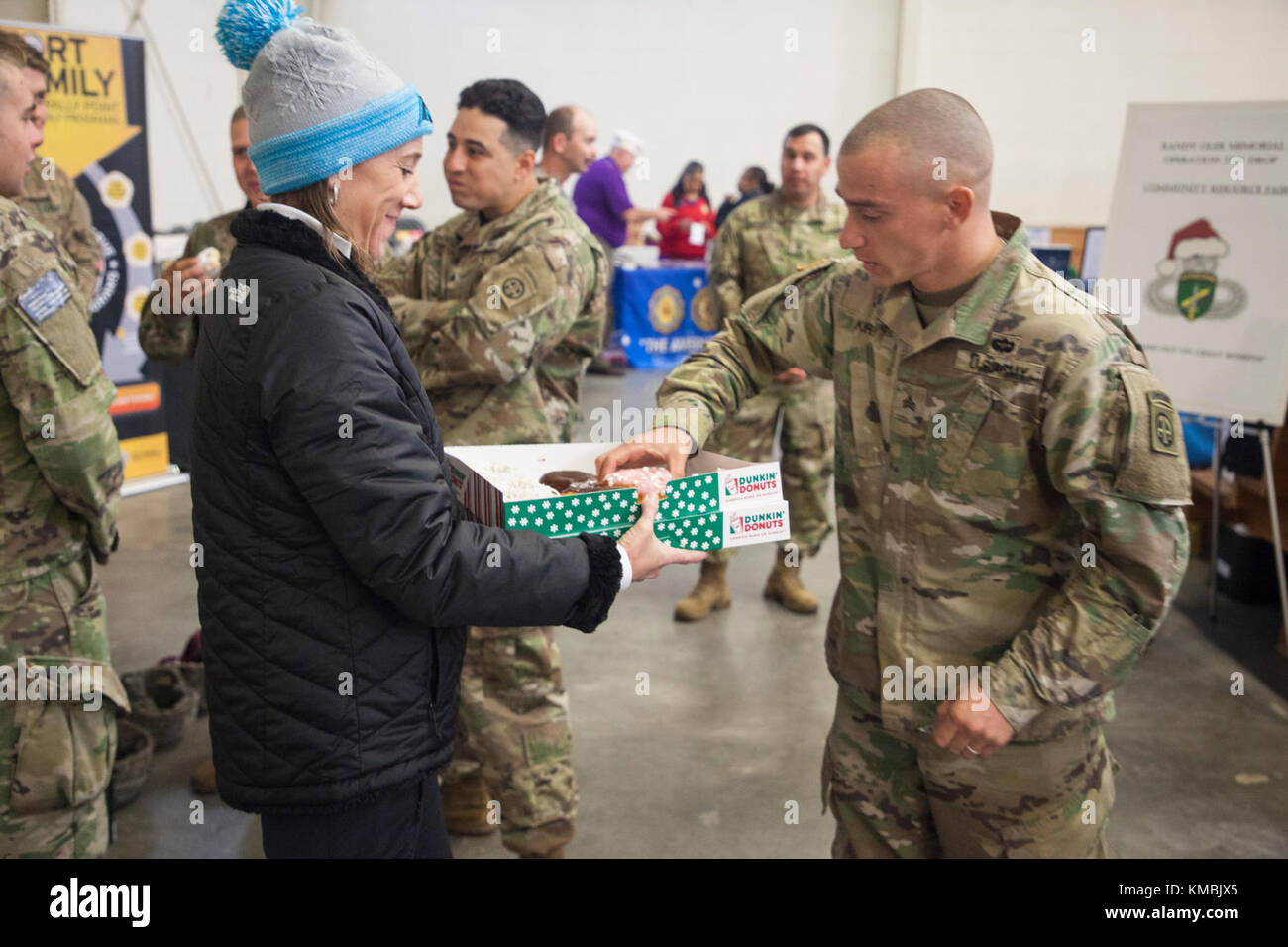 U.S. Army paratrooper takes a donut from a United Service Organizations ...
